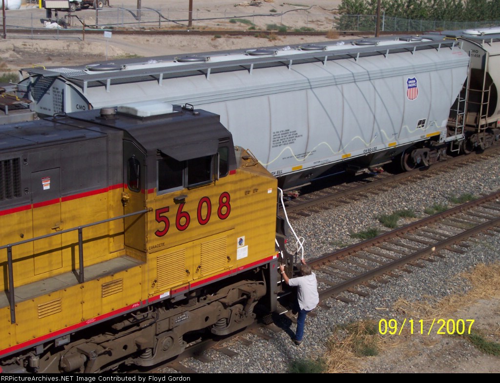 UP 5608 will leave siding shortly as end of eastbound passing freight approaches on mainline.
